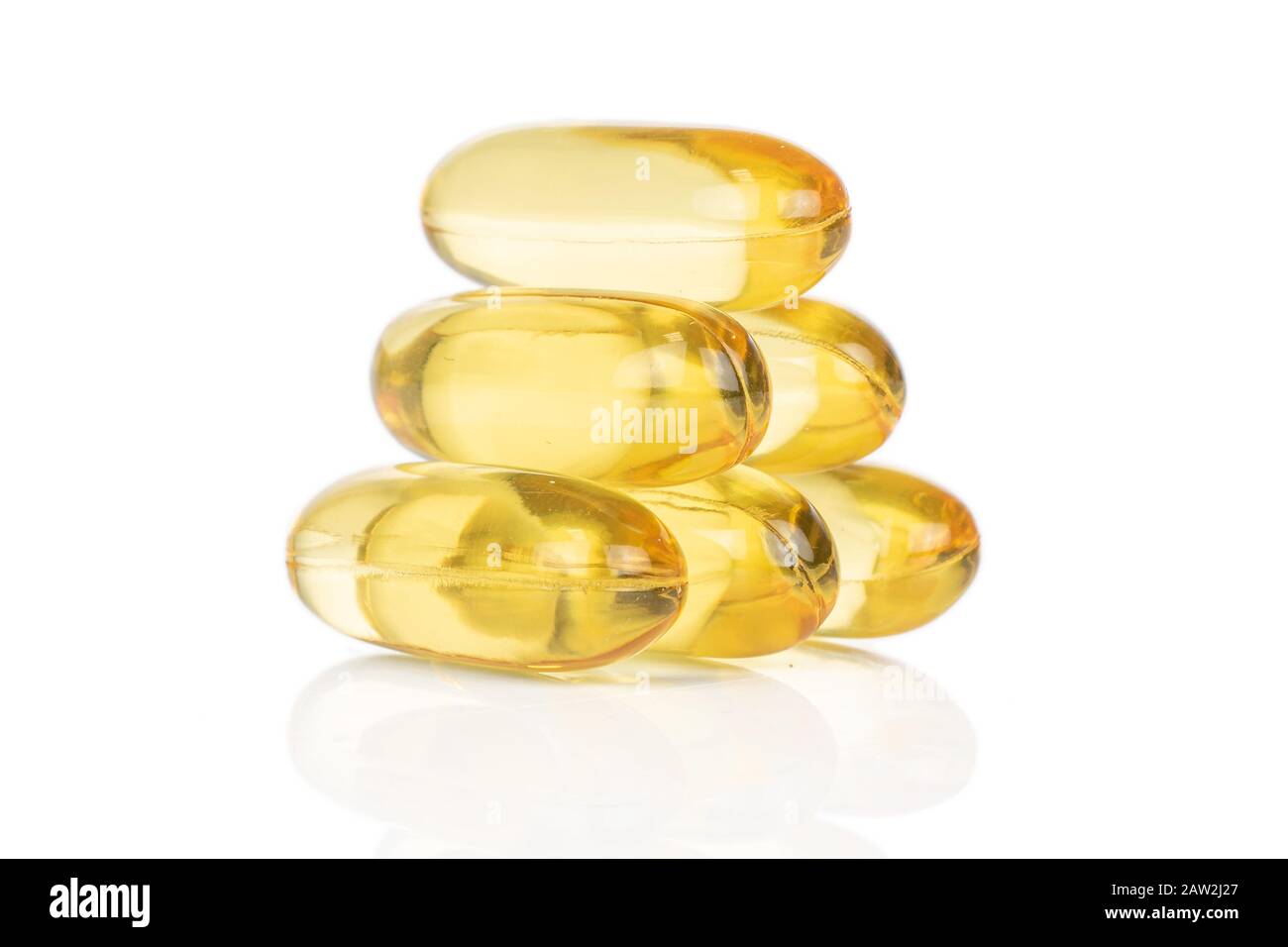 Group of six whole golden fish oil pyramid isolated on white background ...