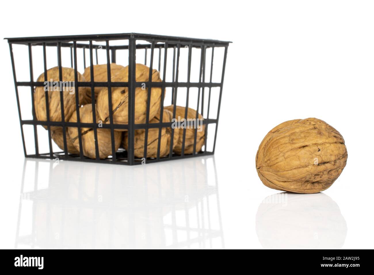 Lot of whole tasty brown walnut in black plastic basket isolated on ...