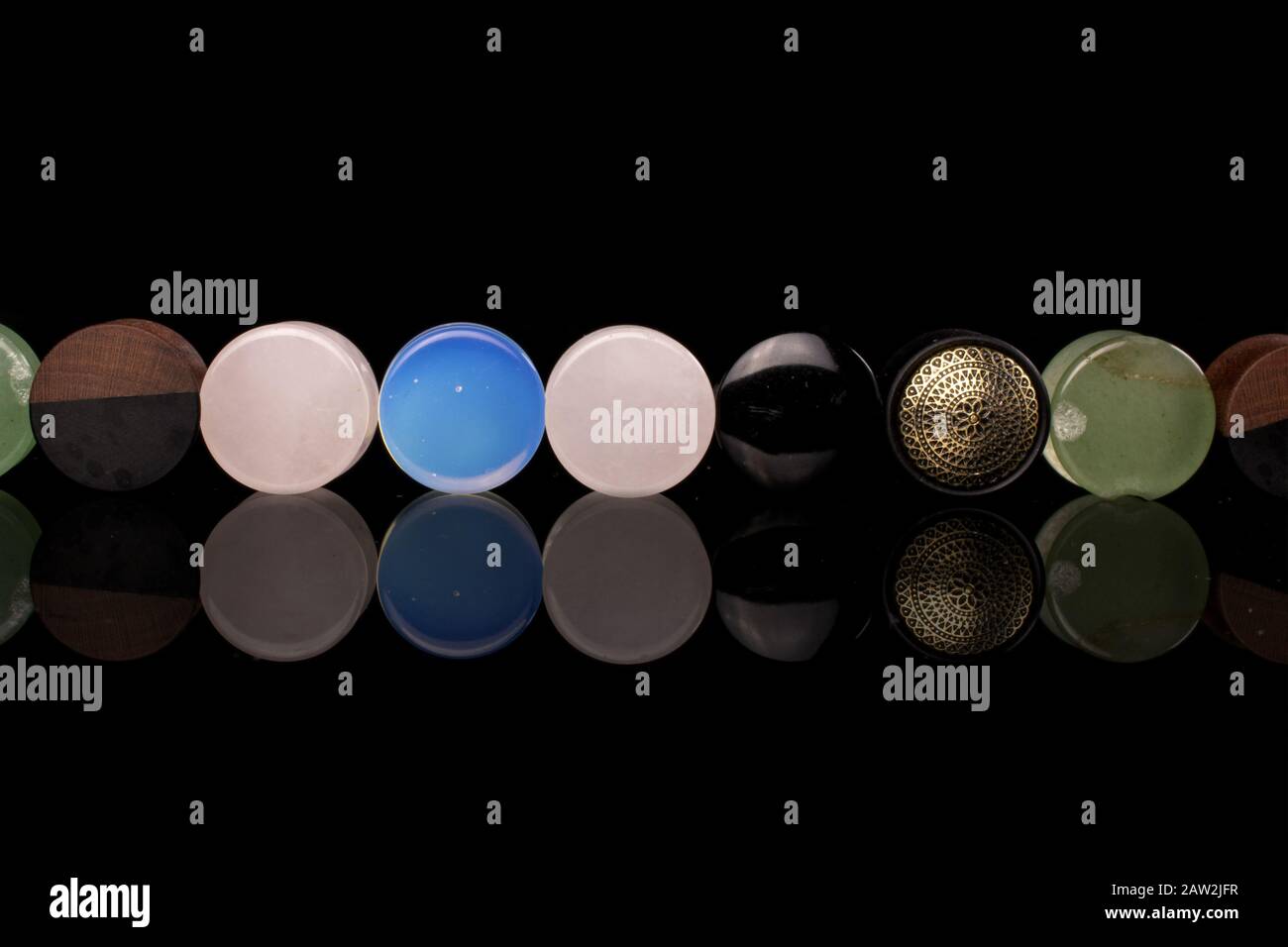 Group of nine whole plug line isolated on black glass Stock Photo - Alamy