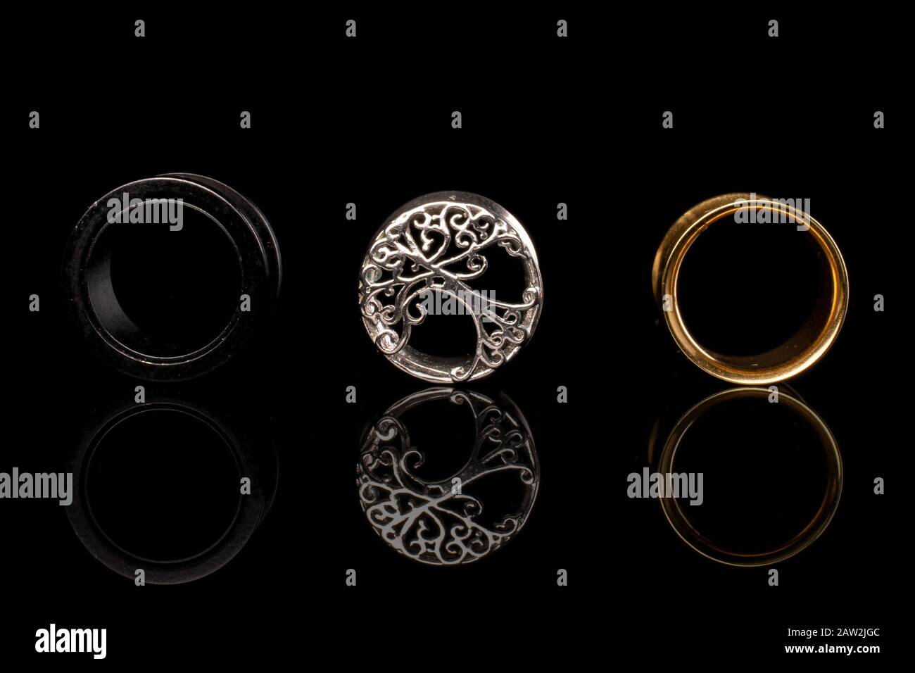 Group of three whole plug in row isolated on black glass Stock Photo ...