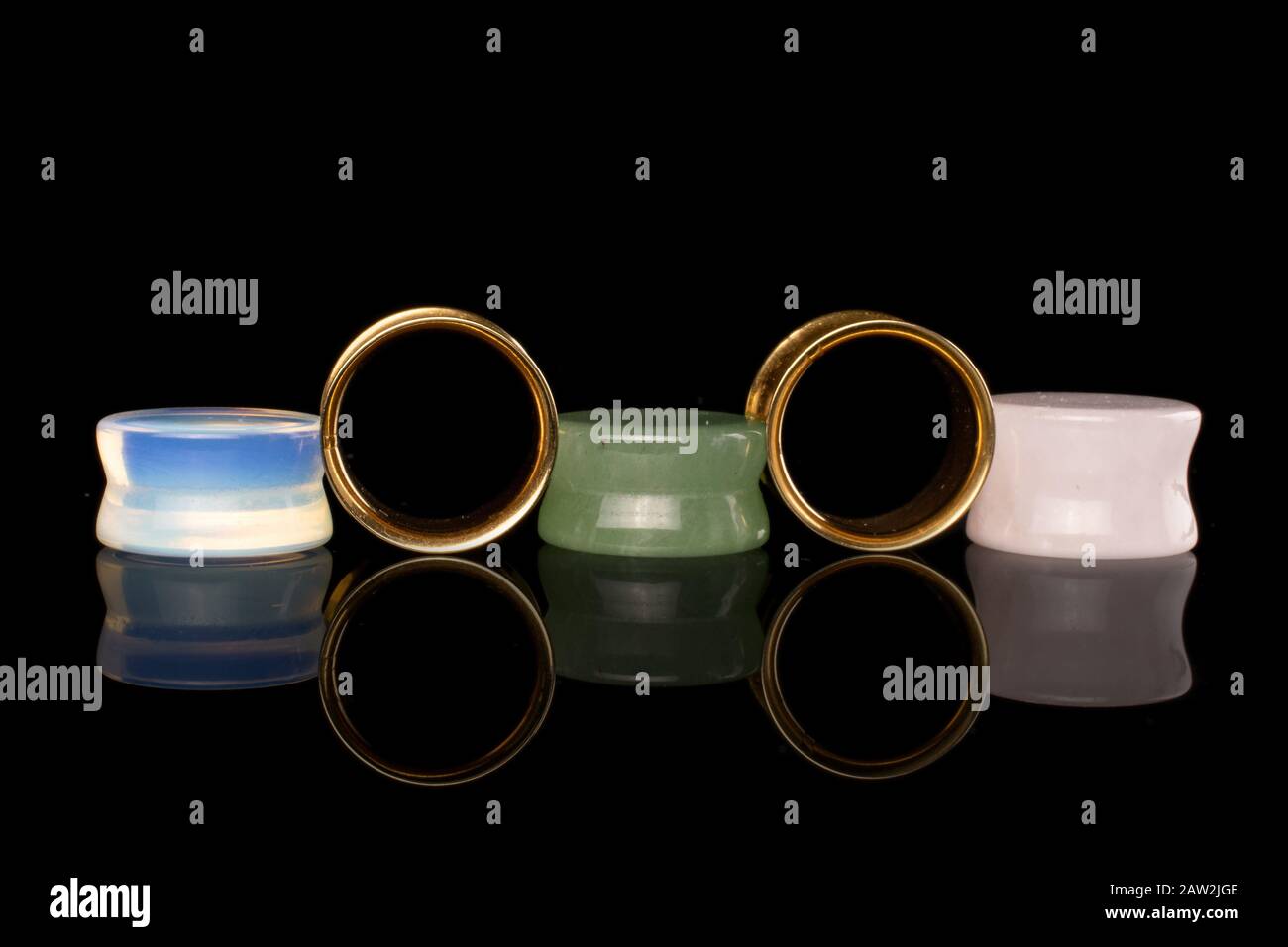 Group of five whole plug isolated on black glass Stock Photo - Alamy