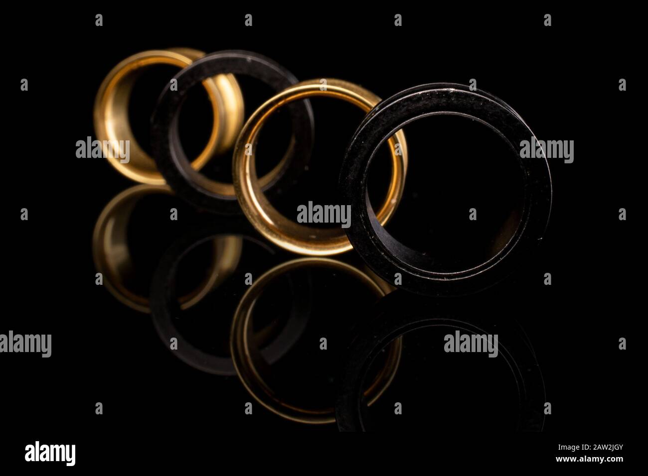 Group of four whole plug diagonal isolated on black glass Stock Photo ...