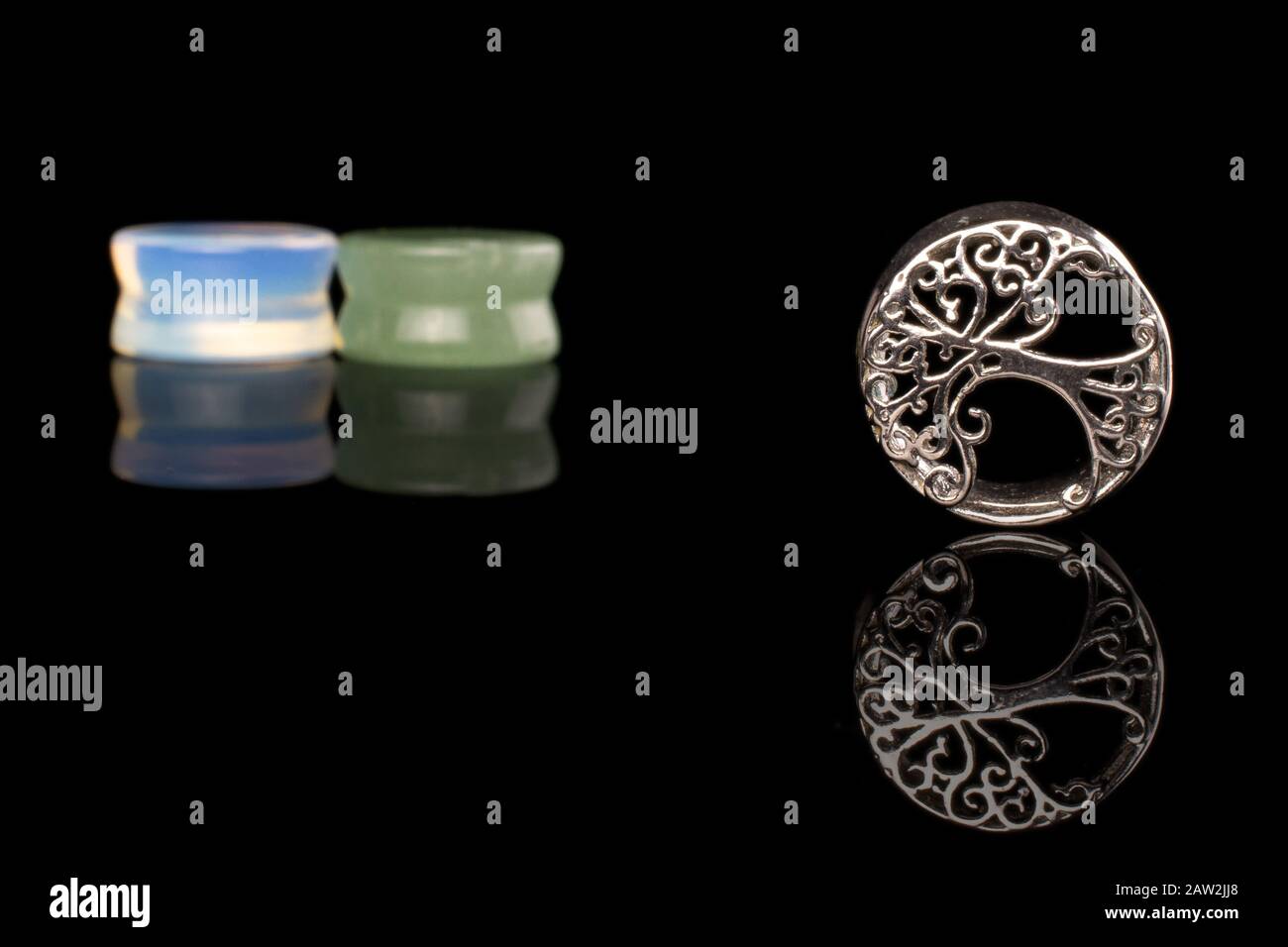 Group of three whole plug isolated on black glass Stock Photo - Alamy