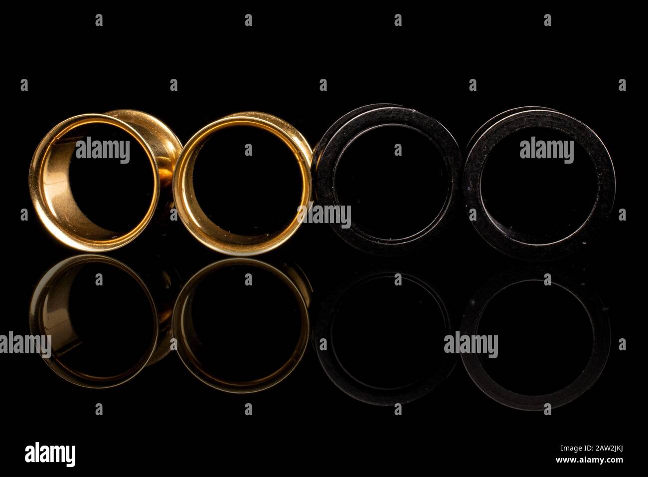 Group of four whole plug isolated on black glass Stock Photo - Alamy