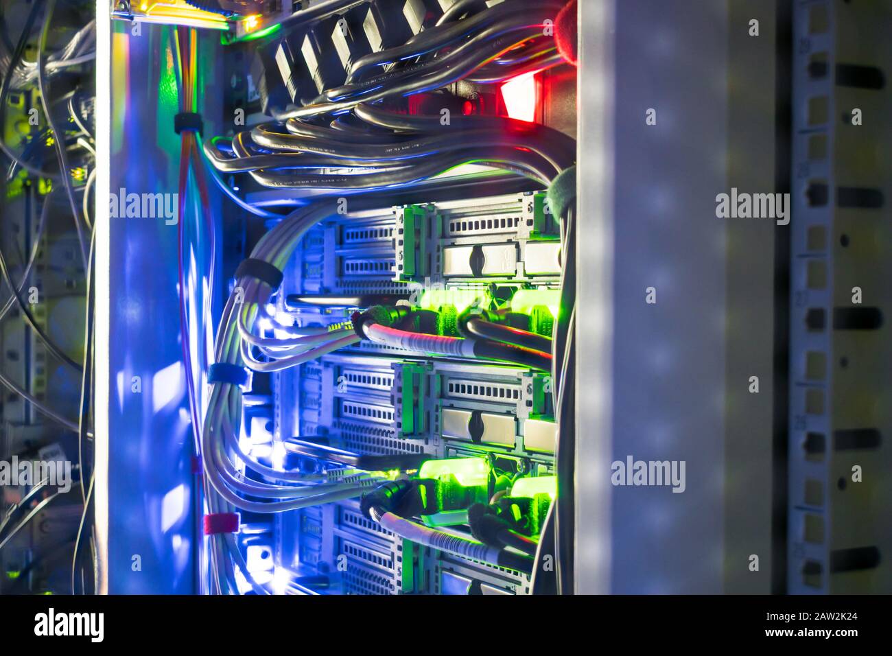 Modern server equipment works in a data center rack. Network interfaces ...