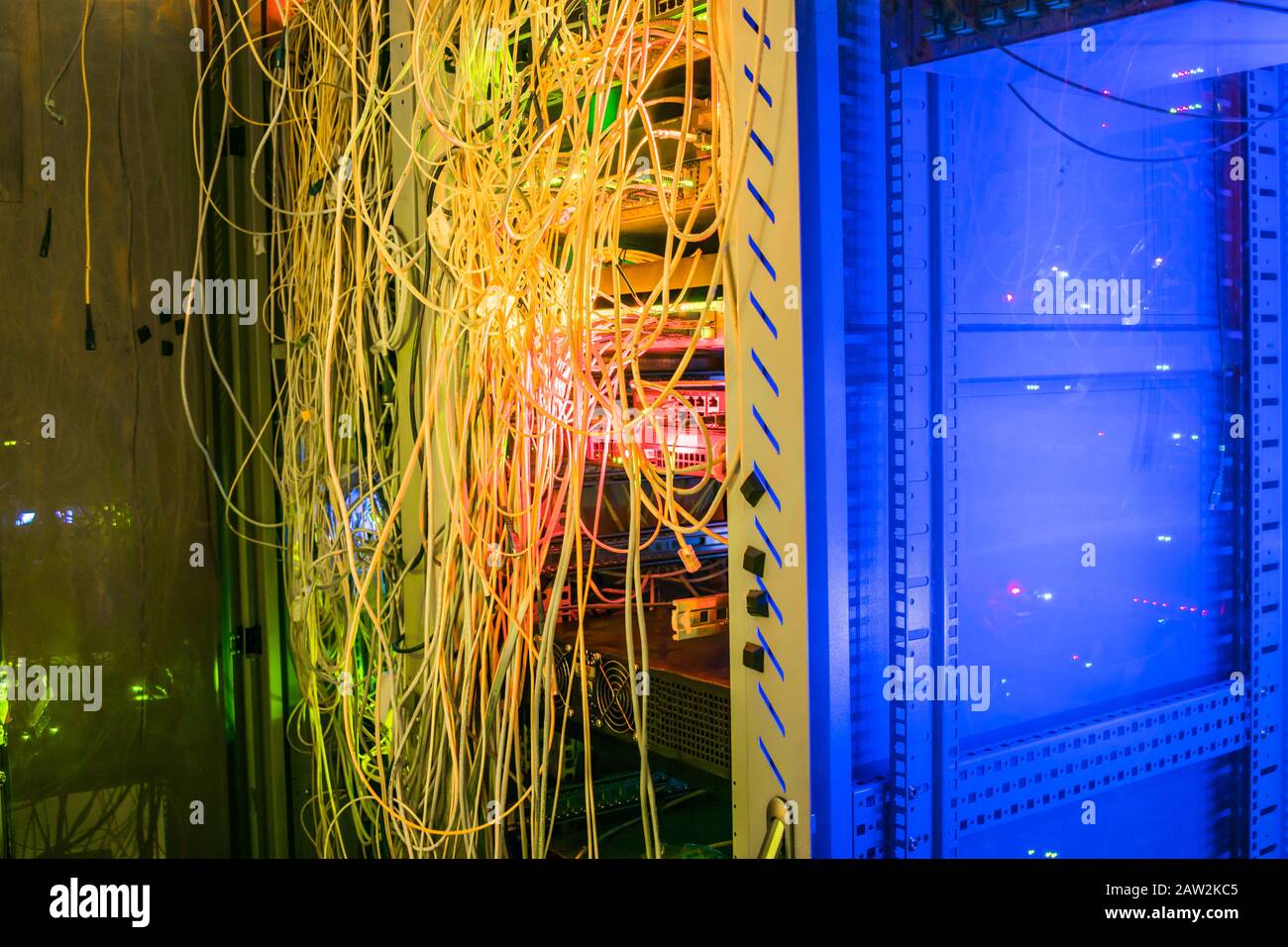 Many optical wires are in the computer case. An empty server rack is ...