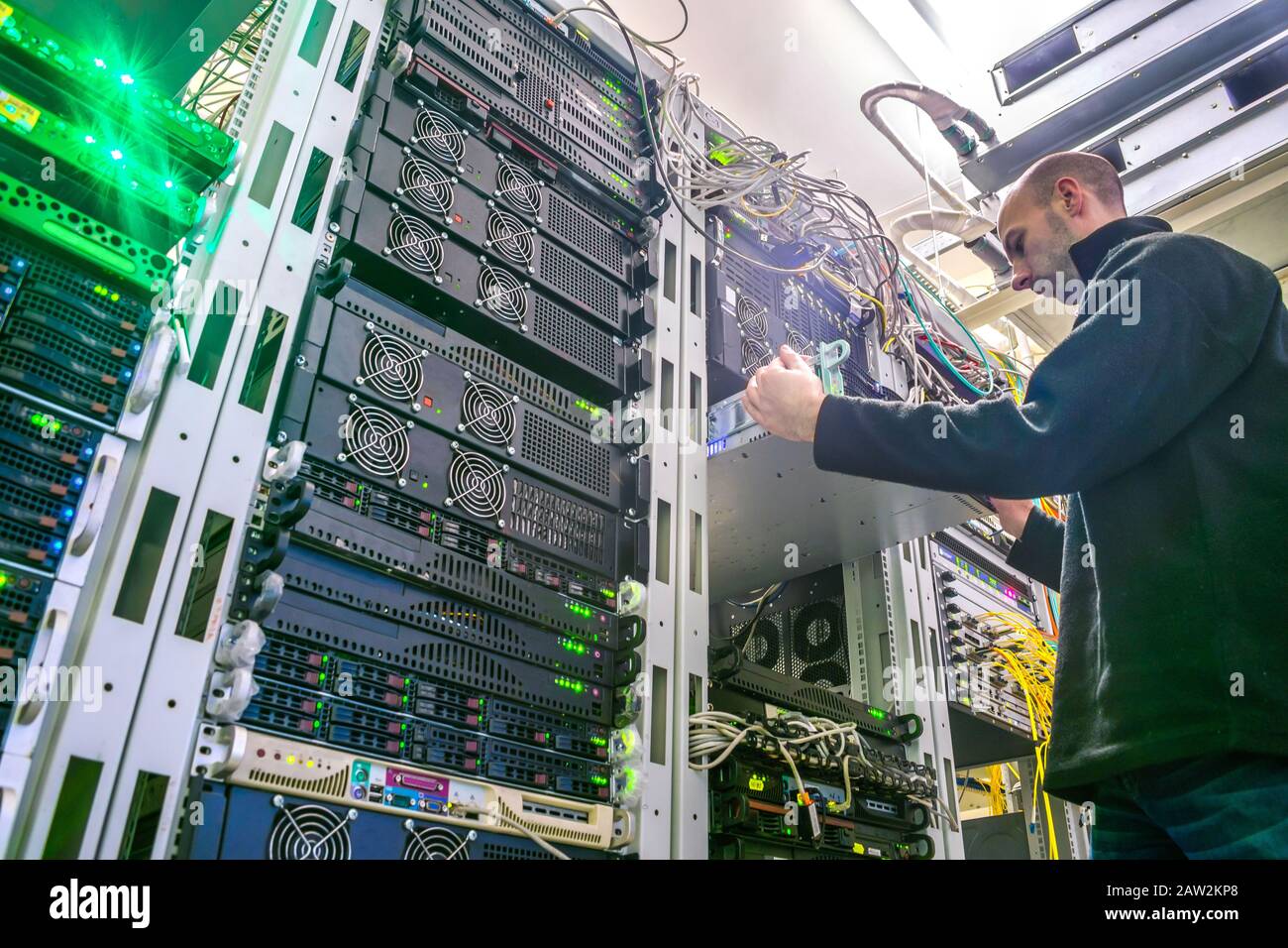The engineer installs the new equipment in the server rack of the data ...