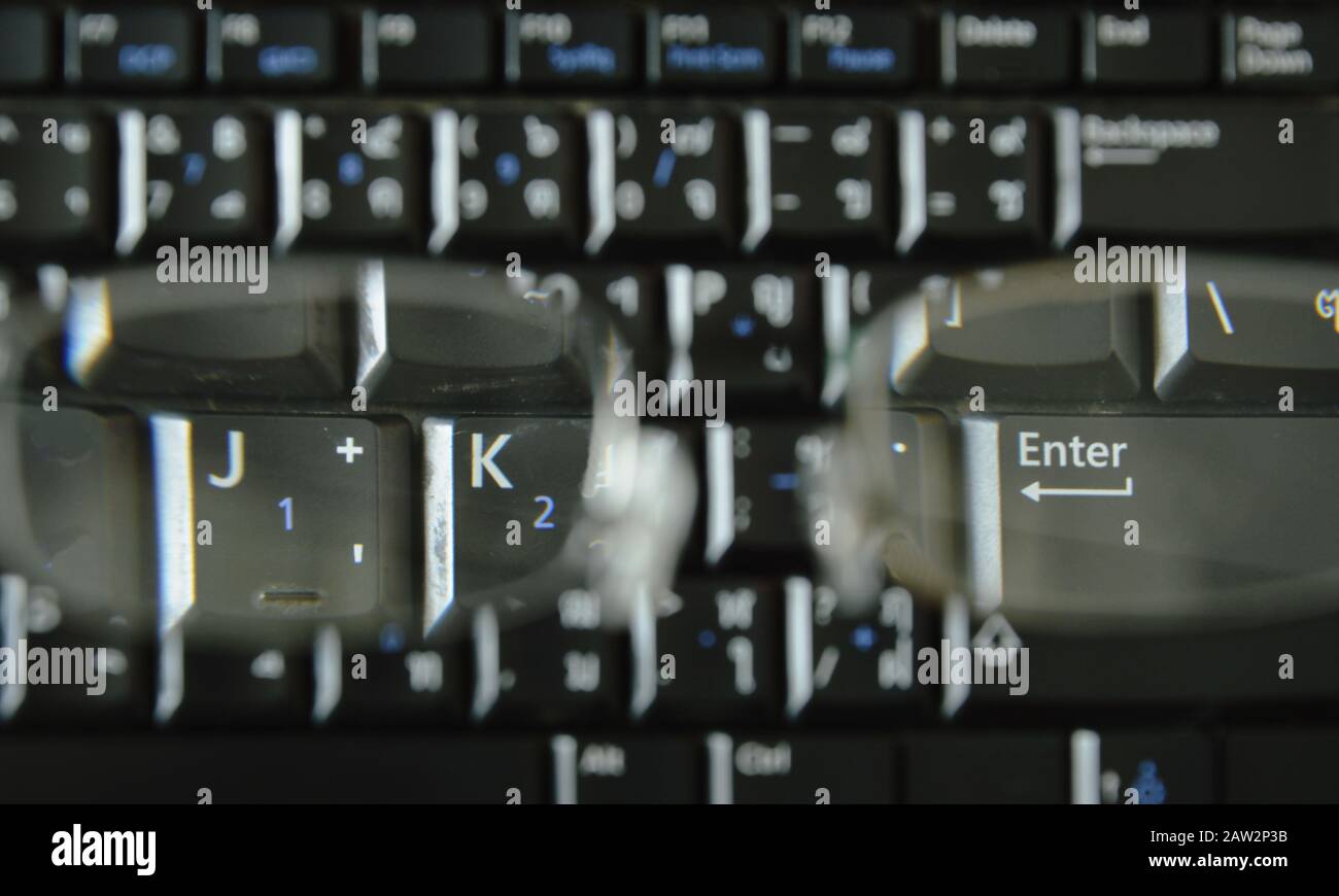 computer notebook keyboard through far sight eyeglasses Stock Photo - Alamy