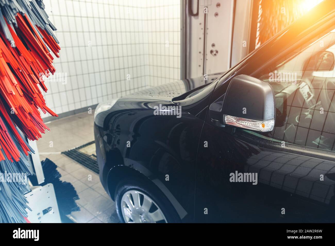 Black modern delivery minivan car cleaning with robot automatic tunnel ...