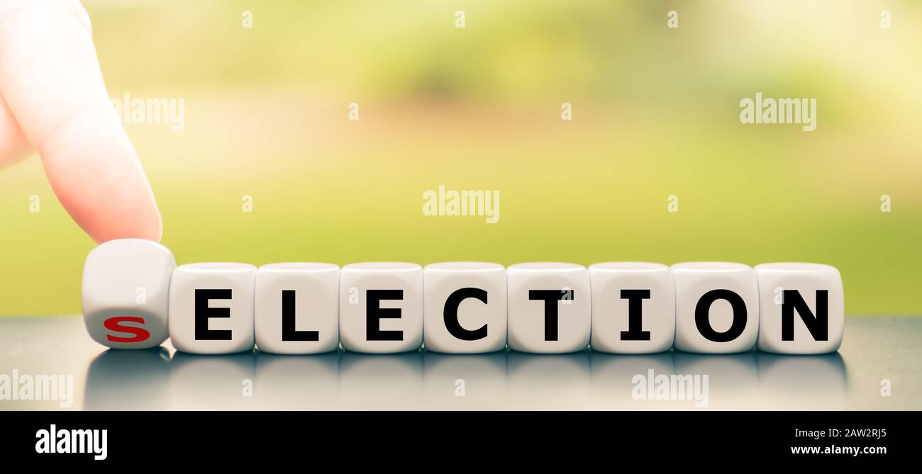 Hand turns a dice and changes the word "selection" to "election Stock ...