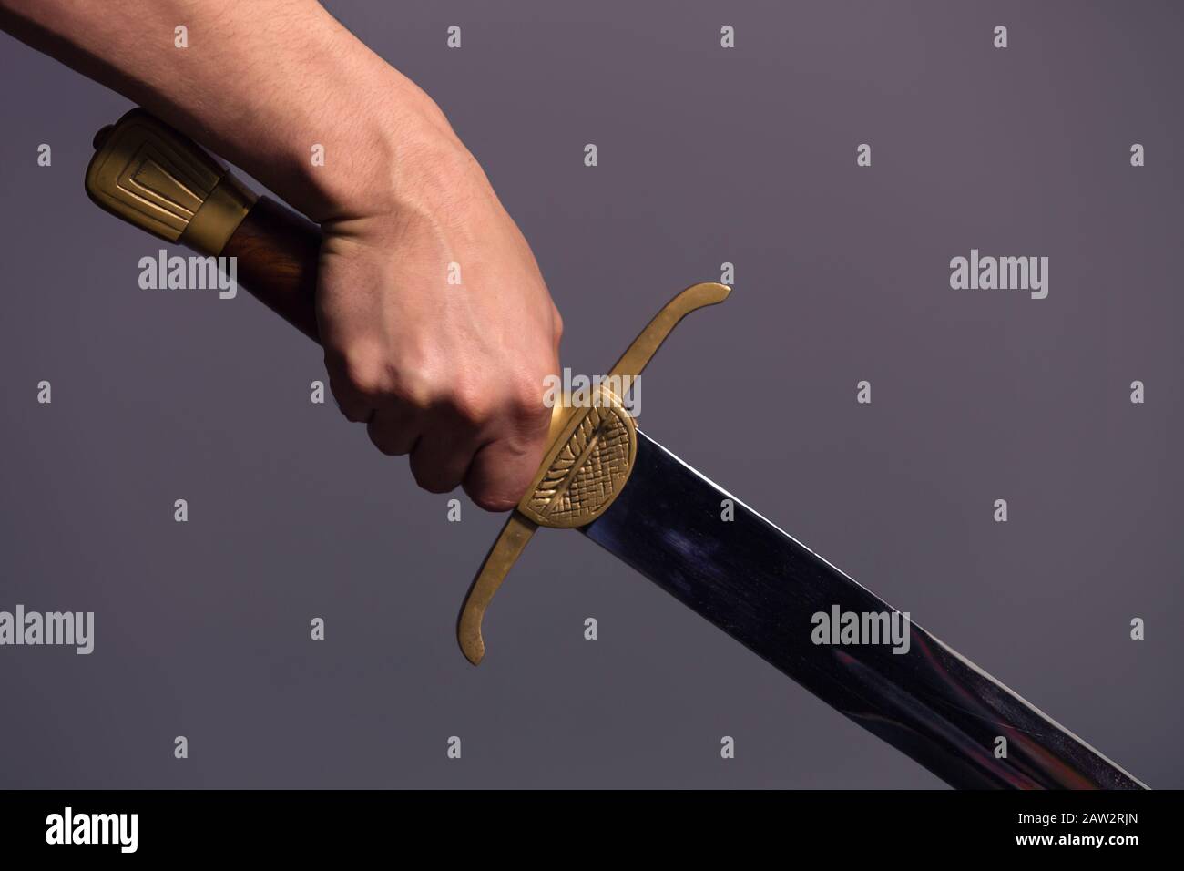 Strong young guy pointing his long sword Stock Photo - Alamy