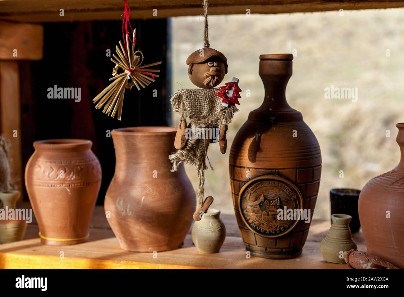 Different types of beautiful hand-painted clay jugs on the counter ...