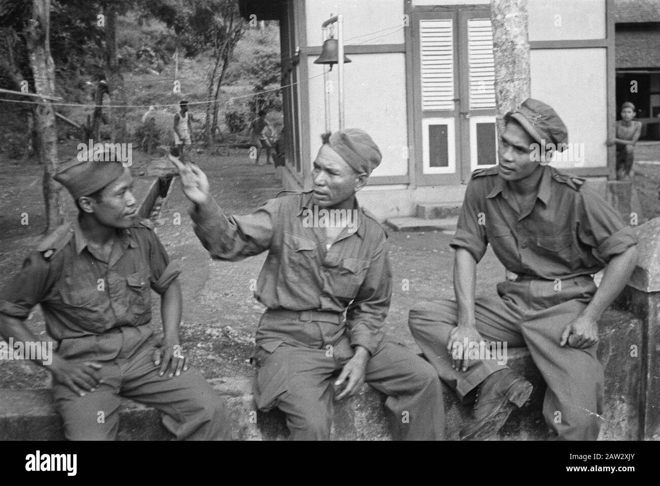 Borneo KNIL soldiers sit on a low wall Date: February 1947 Location ...