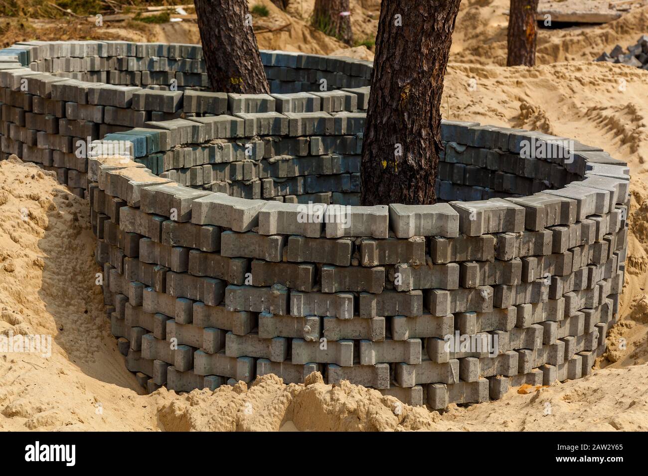 Brick rings around trunks of trees for protection from landslide Stock ...