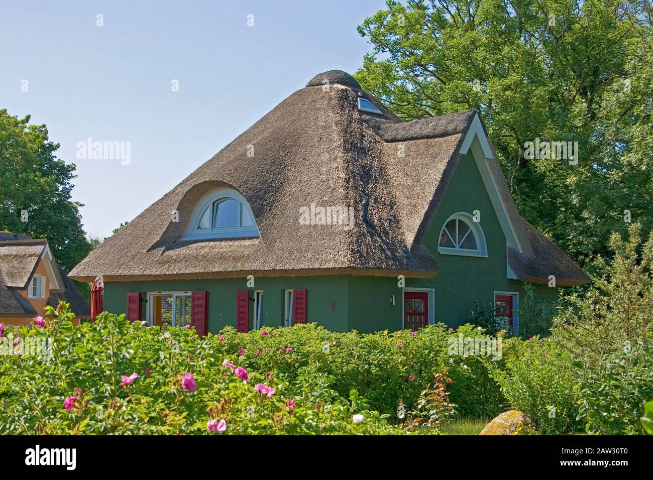 green vacation rental home with green garden Stock Photo - Alamy