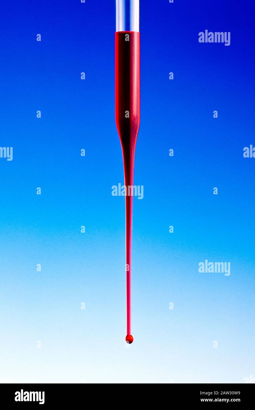 Glass pipette containing red liquid Stock Photo - Alamy
