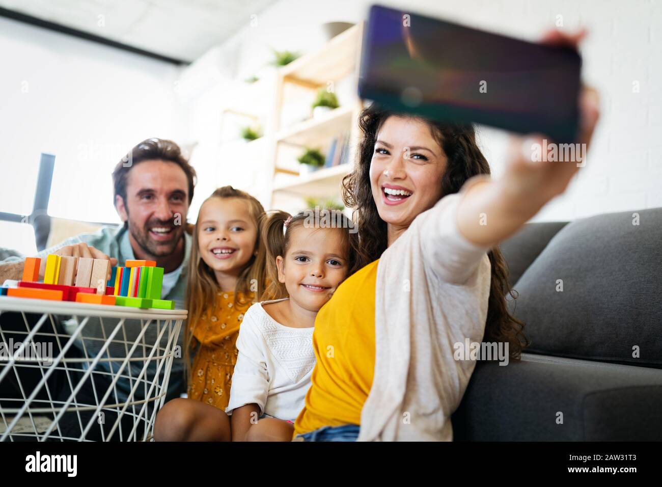 Happy family having fun times at home Stock Photo - Alamy