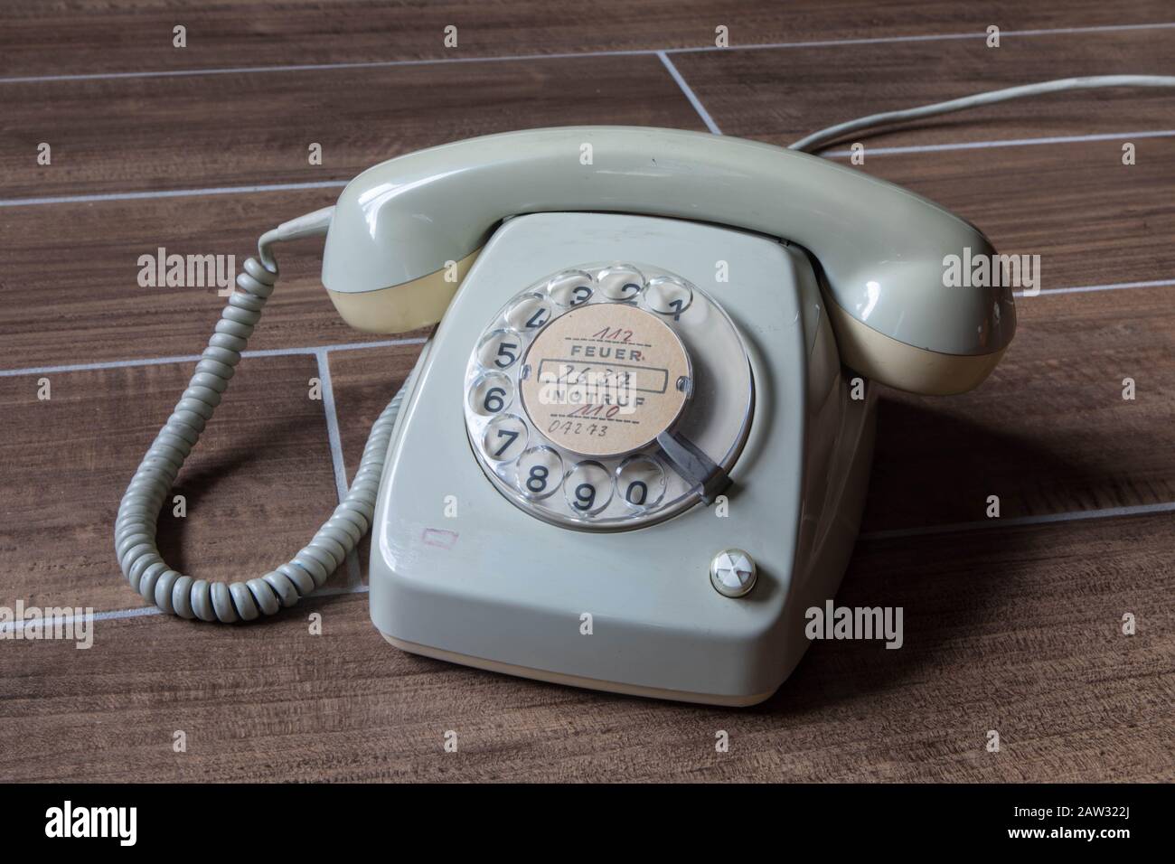 Classic gray telephone on wooden background Stock Photo - Alamy