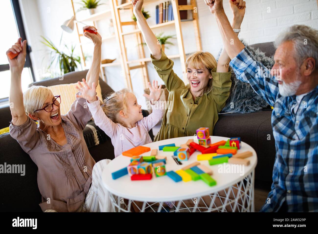 Senior grandparents playing with grandchildren and having fun with ...