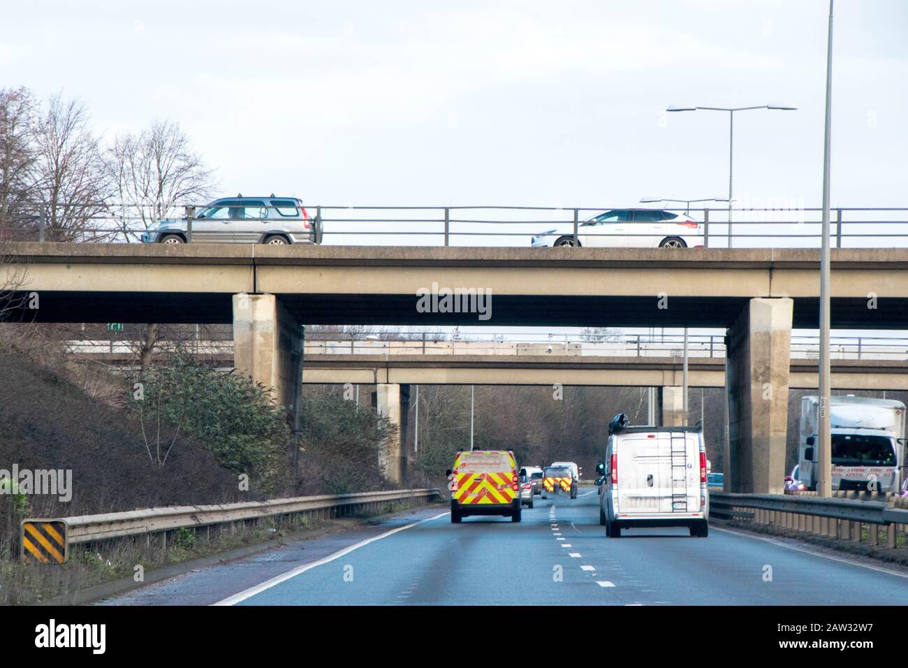 A typical British road leading under a small bridge. The road leading ...