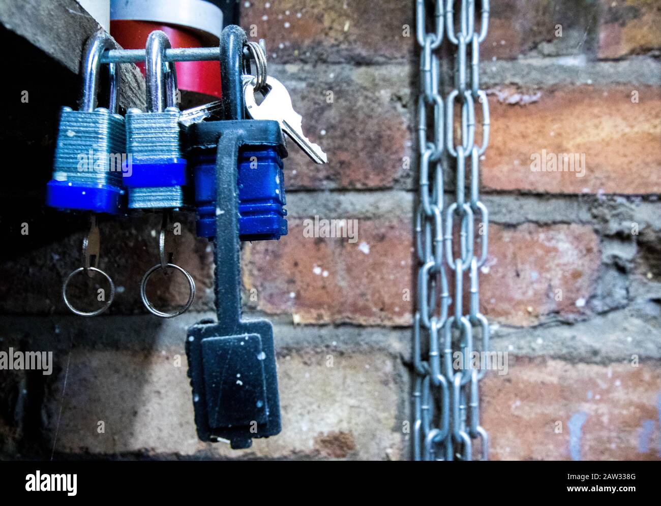 Several heavy duty silver chains hanging from a shed roof Stock Photo ...