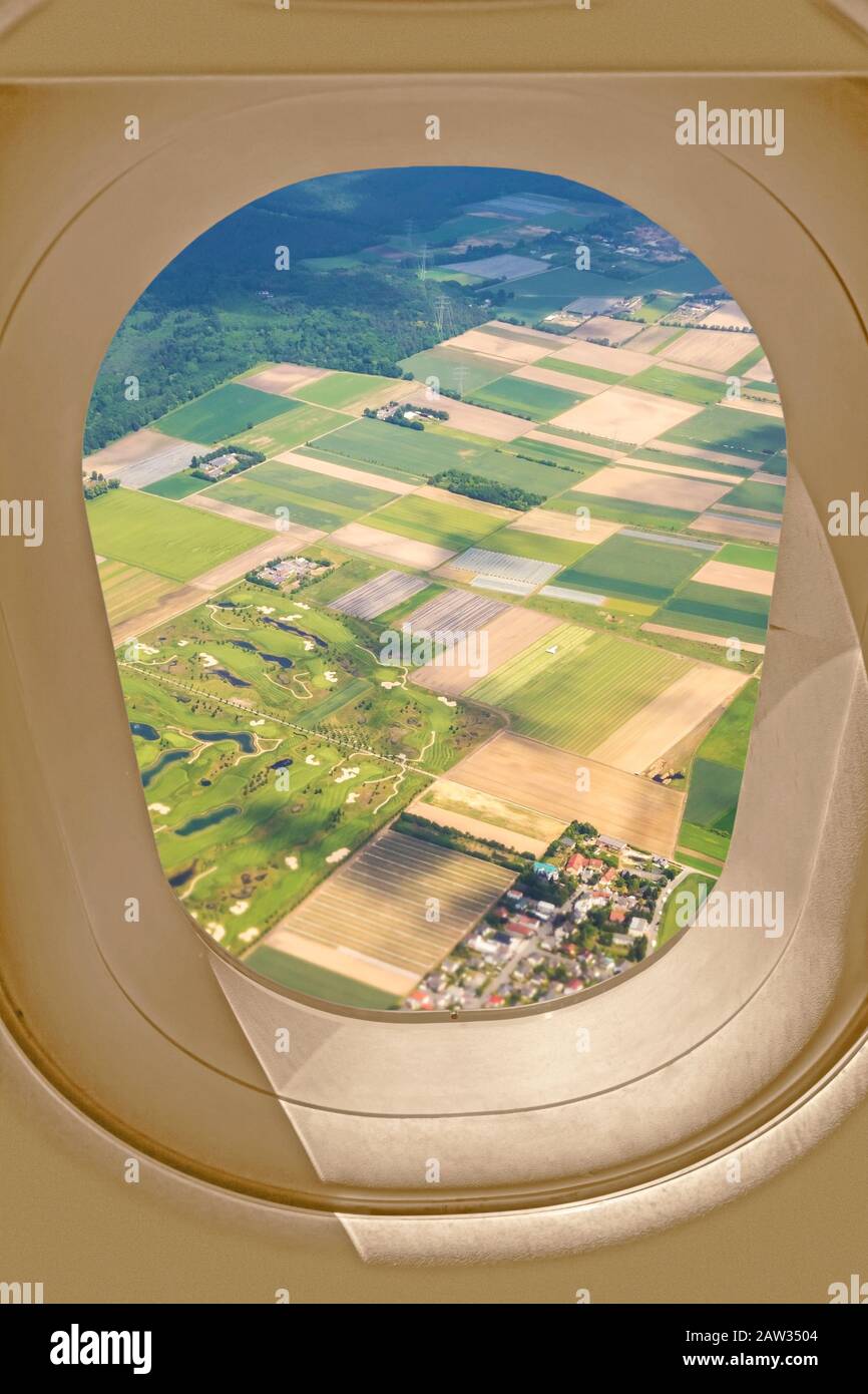 View through airplane window at a golf course, fields and meadows Stock ...