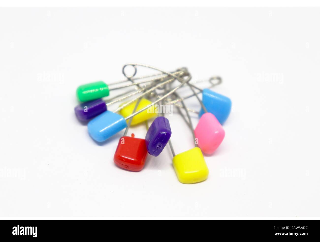 Colorful safety pin isolated on white background Stock Photo - Alamy