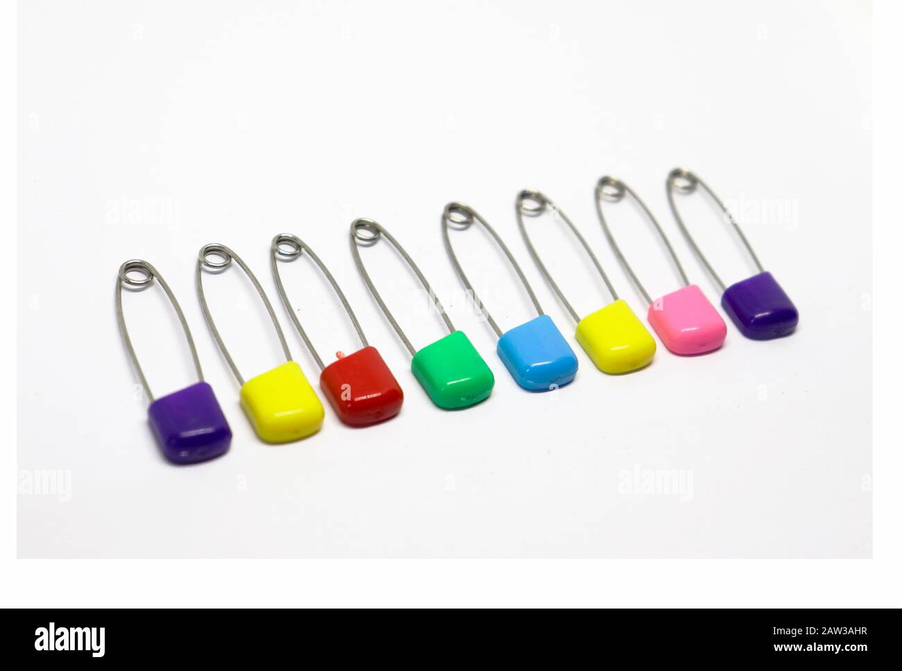 Colorful safety pin isolated on white background Stock Photo - Alamy