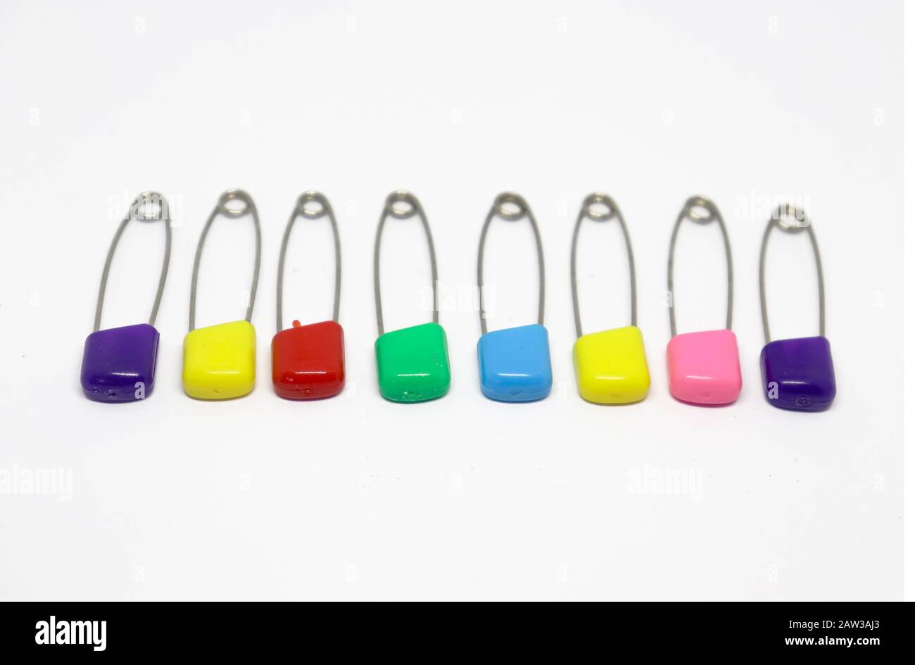 Colorful safety pin isolated on white background Stock Photo - Alamy