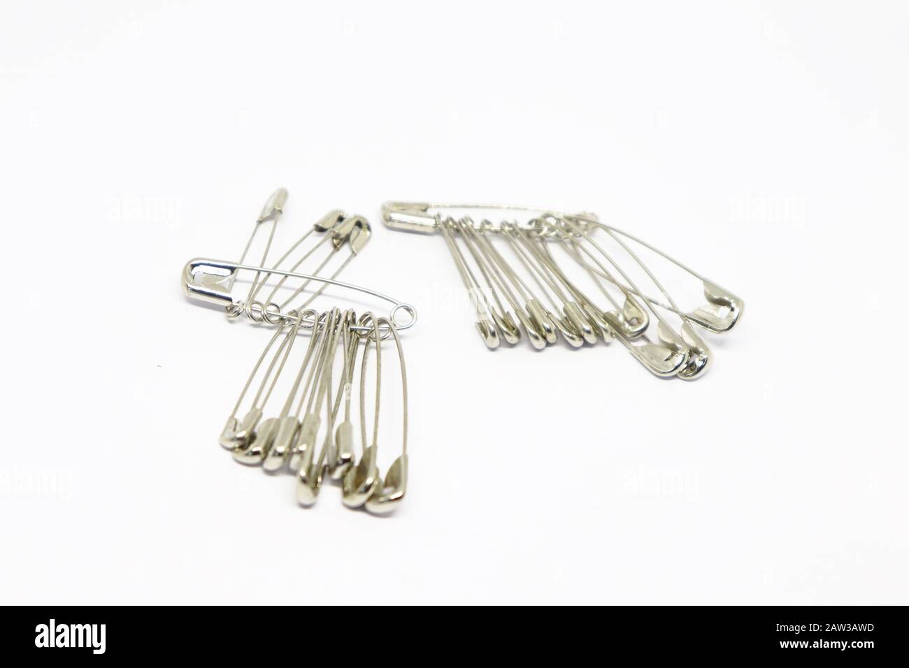 Steel safety pin isolated on white background Stock Photo - Alamy