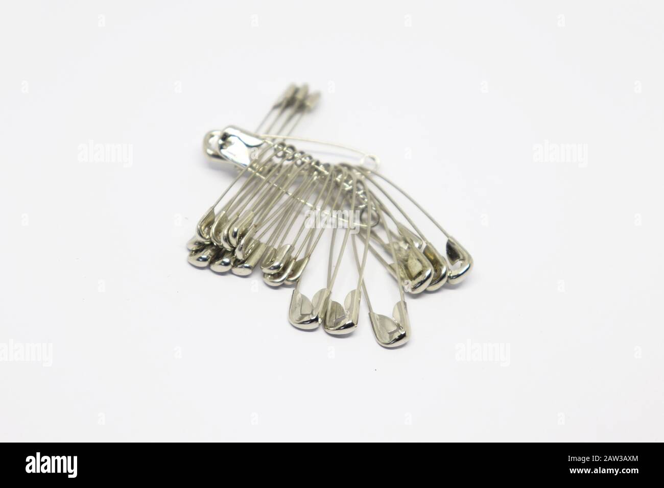 Steel safety pin isolated on white background Stock Photo - Alamy