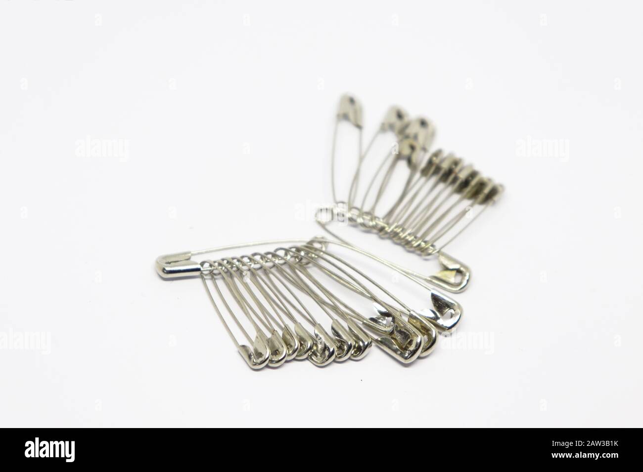 Steel safety pin isolated on white background Stock Photo - Alamy
