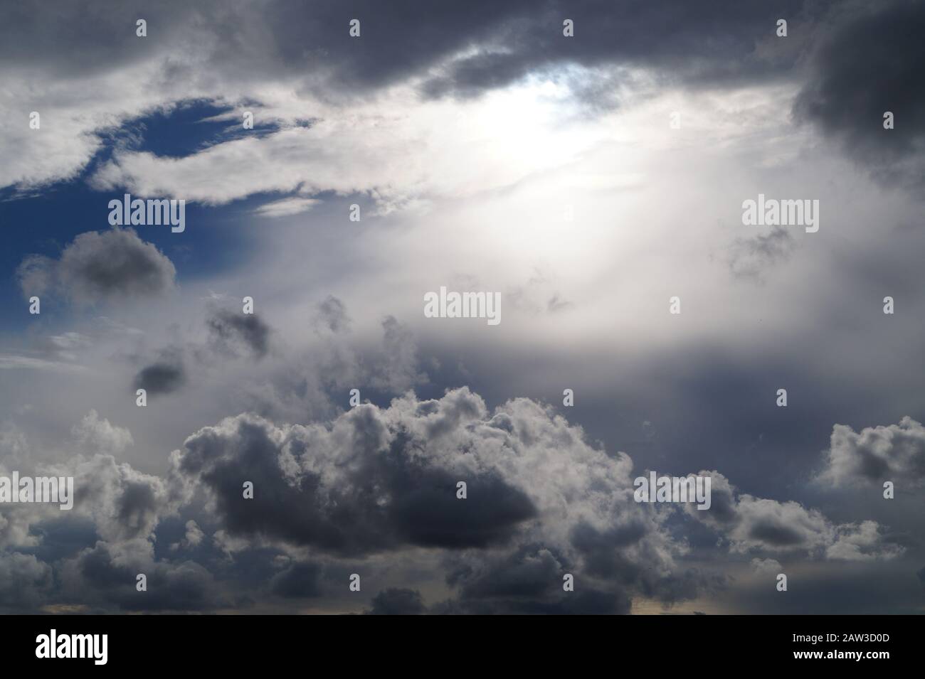 Sun breaking through clouds Stock Photo - Alamy