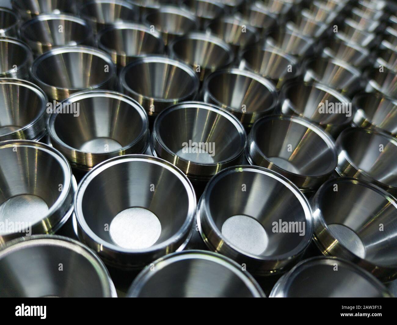 Shiny silver color stainless steel parts background. Regular industrial ...