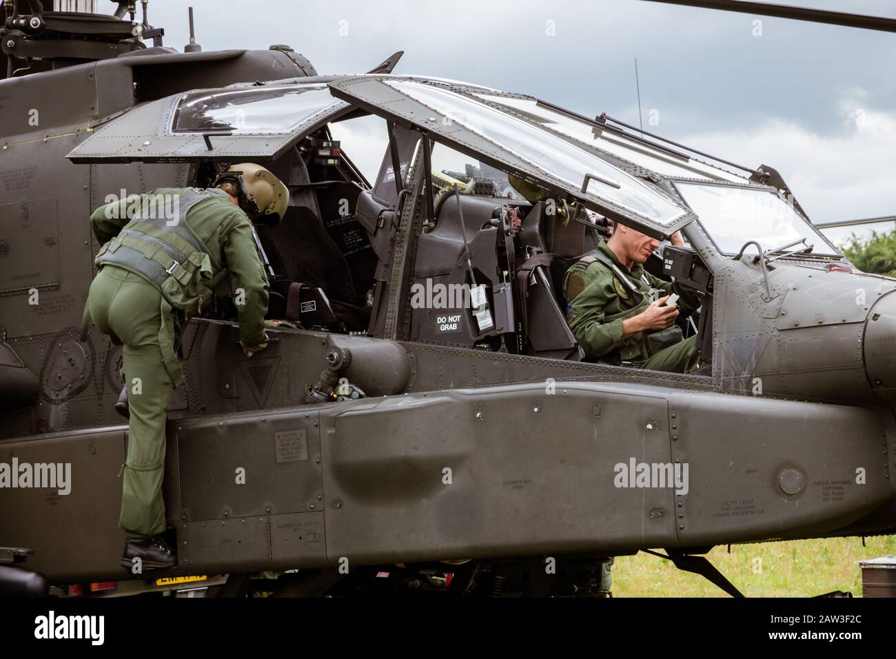 GILZE-RIJEN, NETHERLANDS - JUN 20, 2014: Pilot and gunner in an AH-64 ...