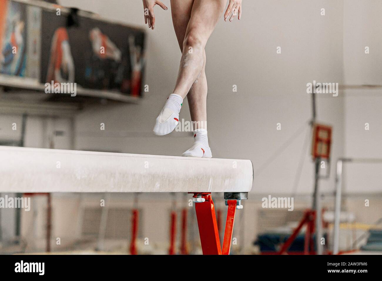 girl gymnast athlete exercise on balance beam in gymnastics gym Stock ...