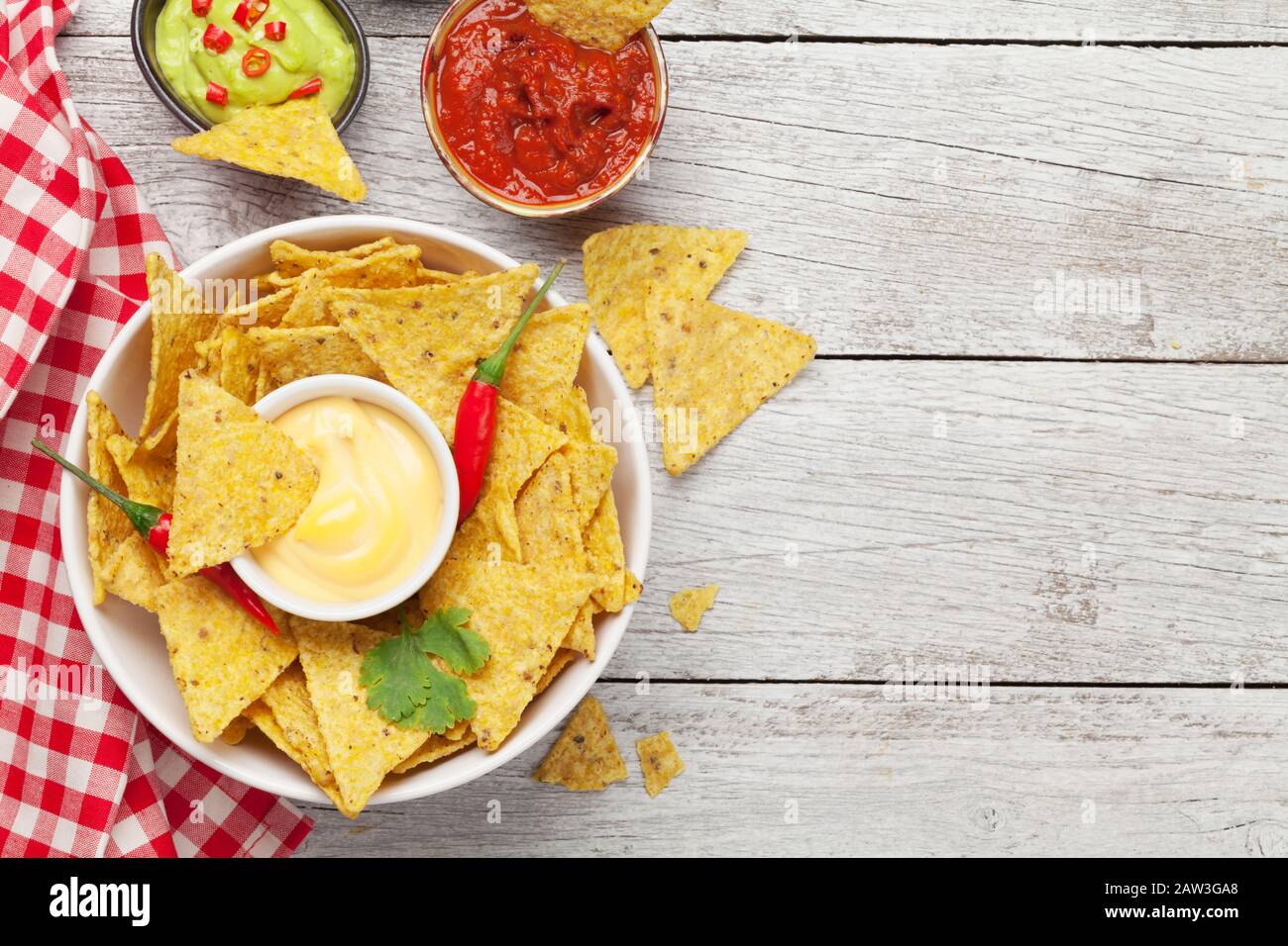 Mexican nachos chips with various sauces - guacamole, salsa and cheese ...