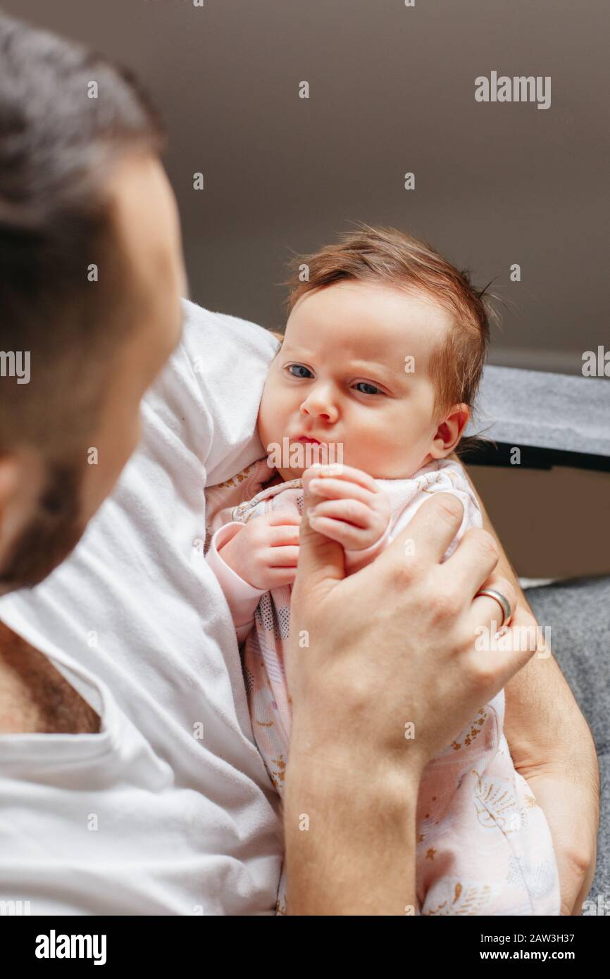 Funny cute adorable baby. Father holding carrying funny newborn infant ...