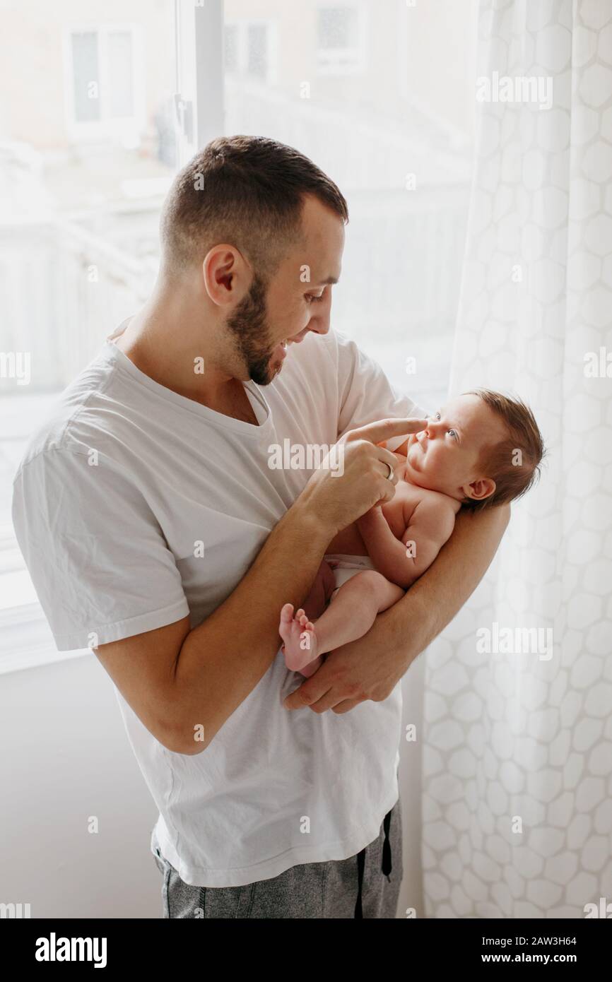 Happy Caucasian father holding newborn baby. Male man parent rocking ...