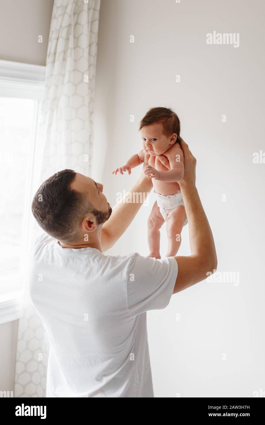 Happy Caucasian father holding newborn baby. Male bearded man parent ...