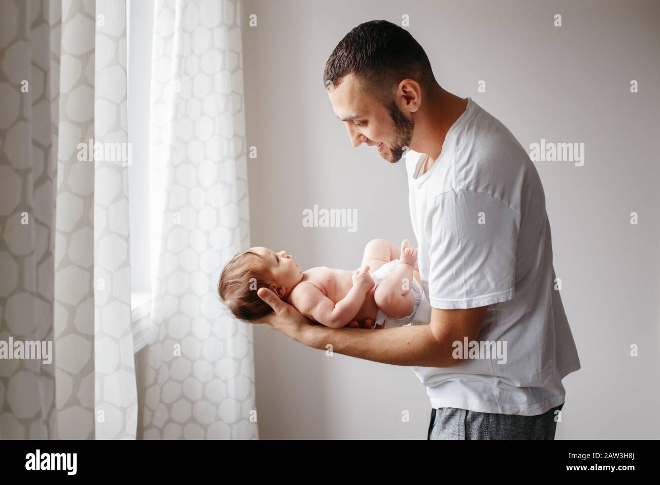 Happy Caucasian father holding newborn baby. Male bearded man parent ...