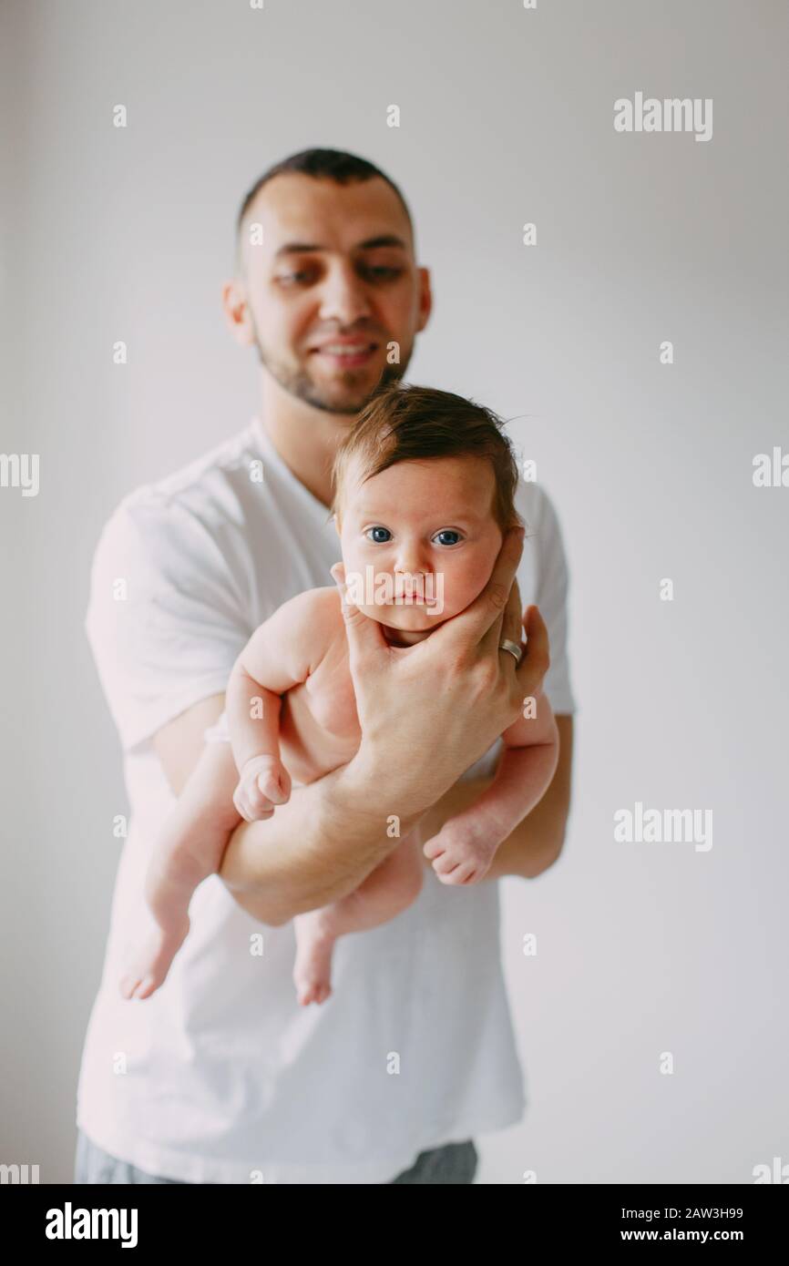 Happy Caucasian father holding newborn baby. Male bearded man parent ...