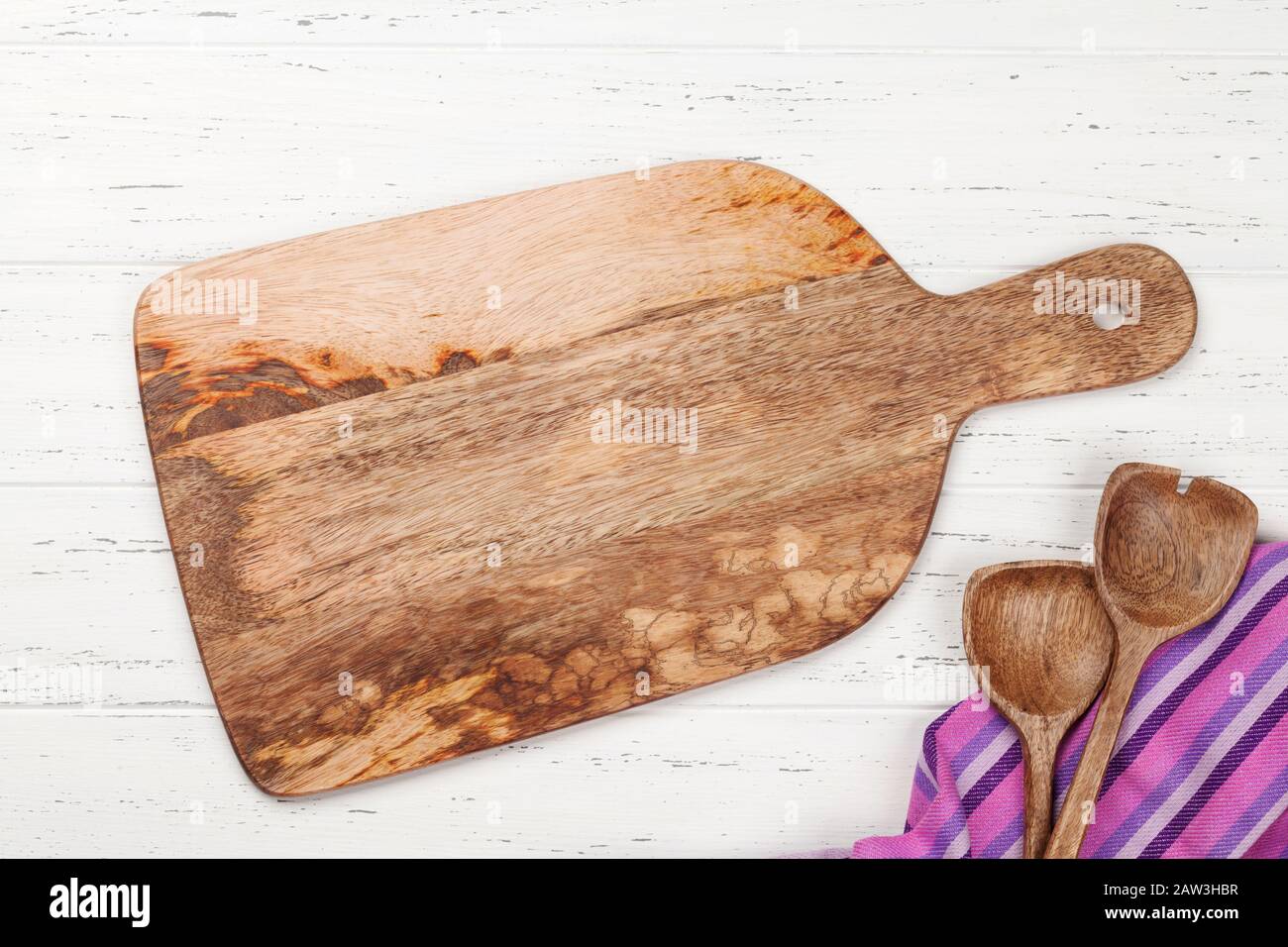 Kitchen table with utensils, cutting board and tablecloth and space for ...