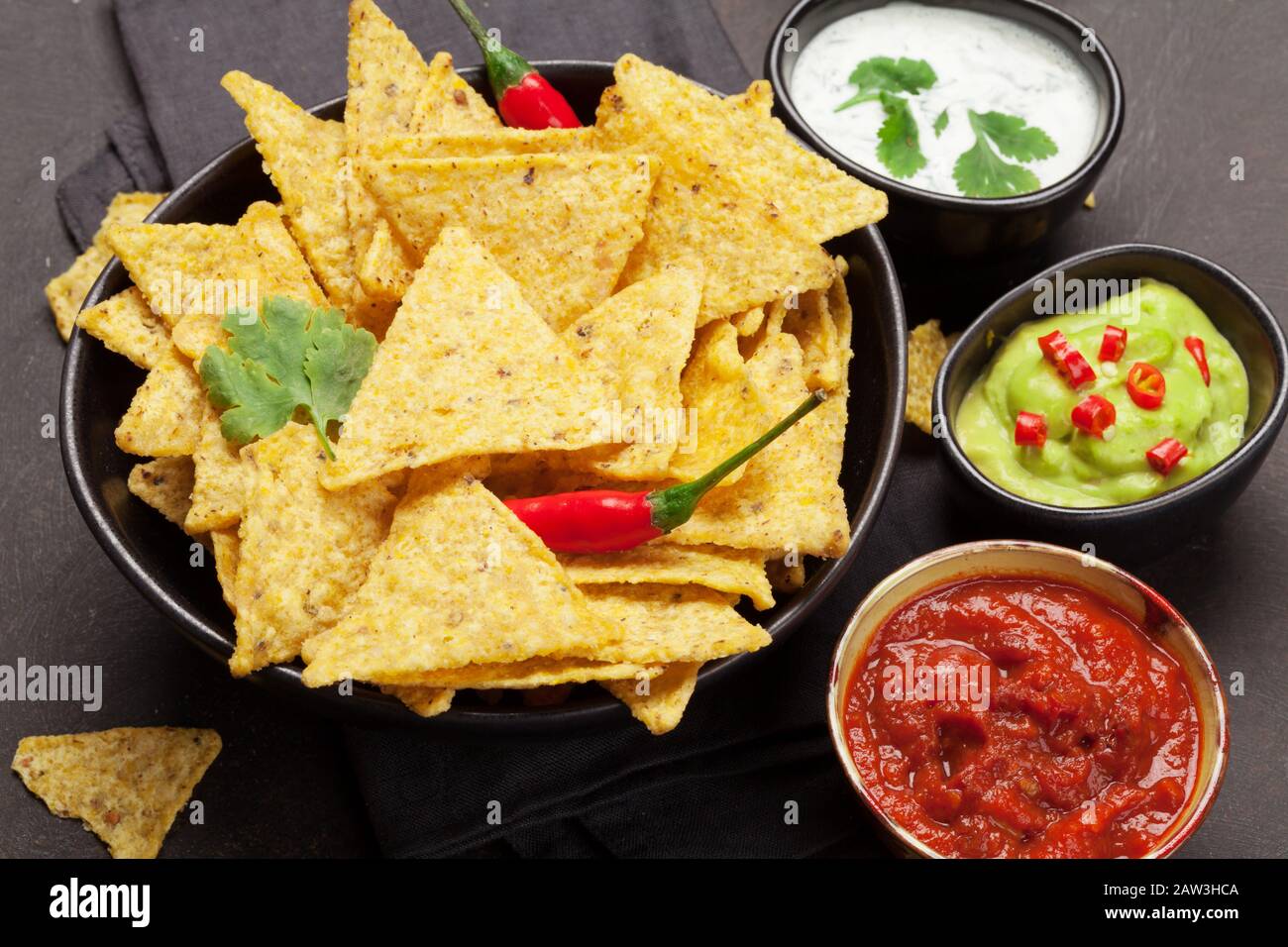 Mexican nachos chips with various sauces - guacamole, salsa, cheese and ...