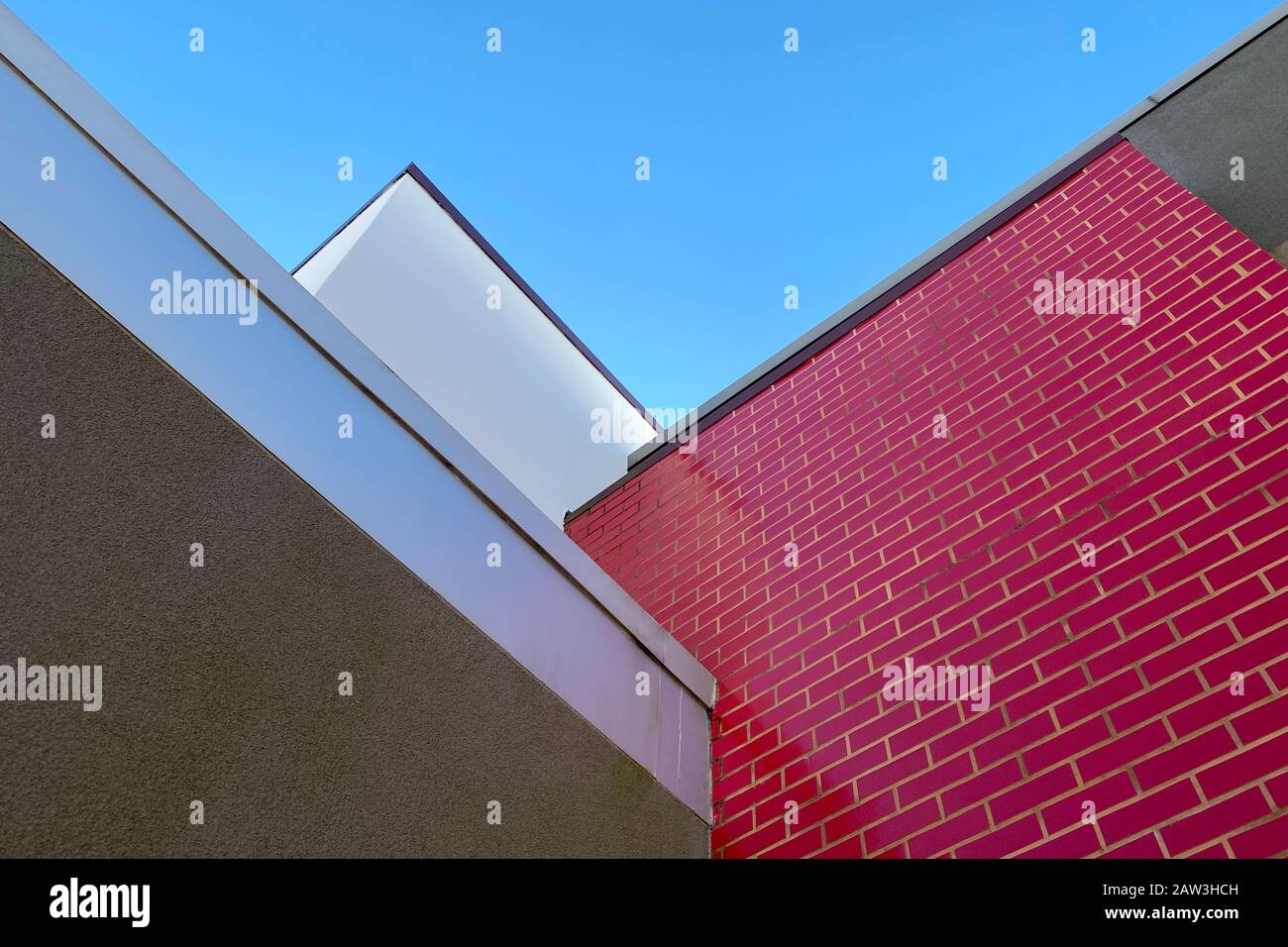 a red brick building with angle roof line Stock Photo - Alamy