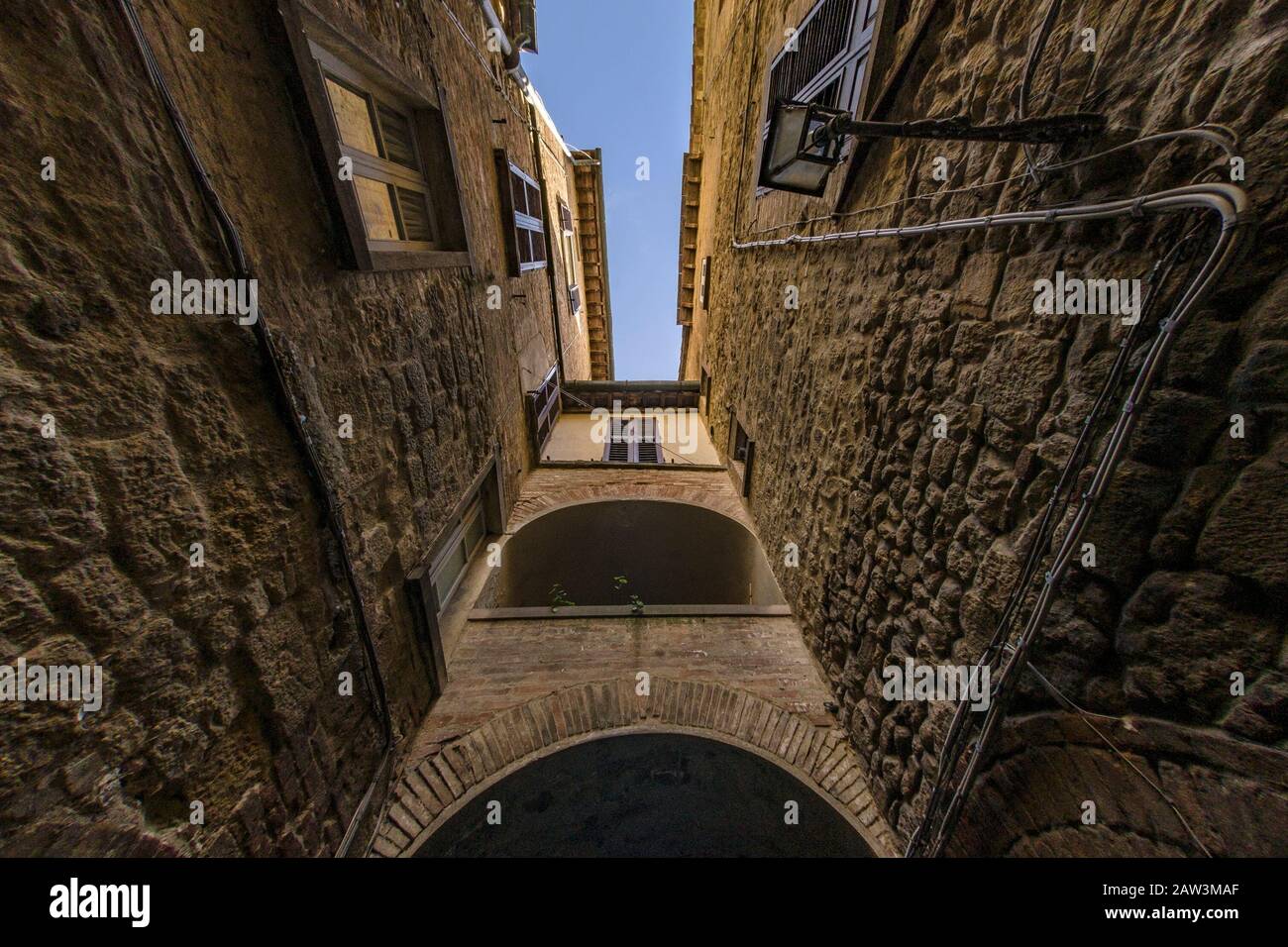 Ancient village with passage under archway in Tuscany Stock Photo - Alamy