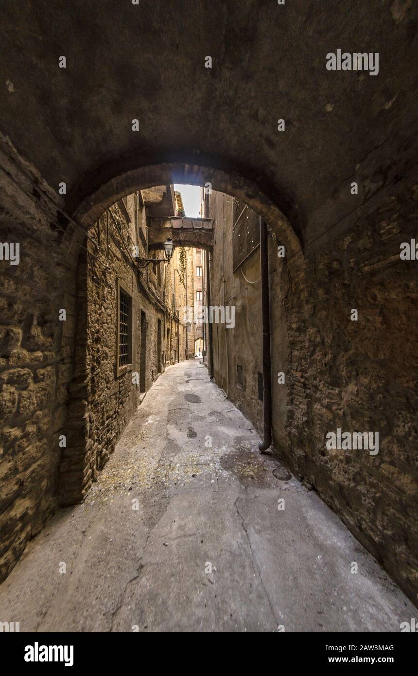 Ancient village with passage under archway in Tuscany Stock Photo - Alamy