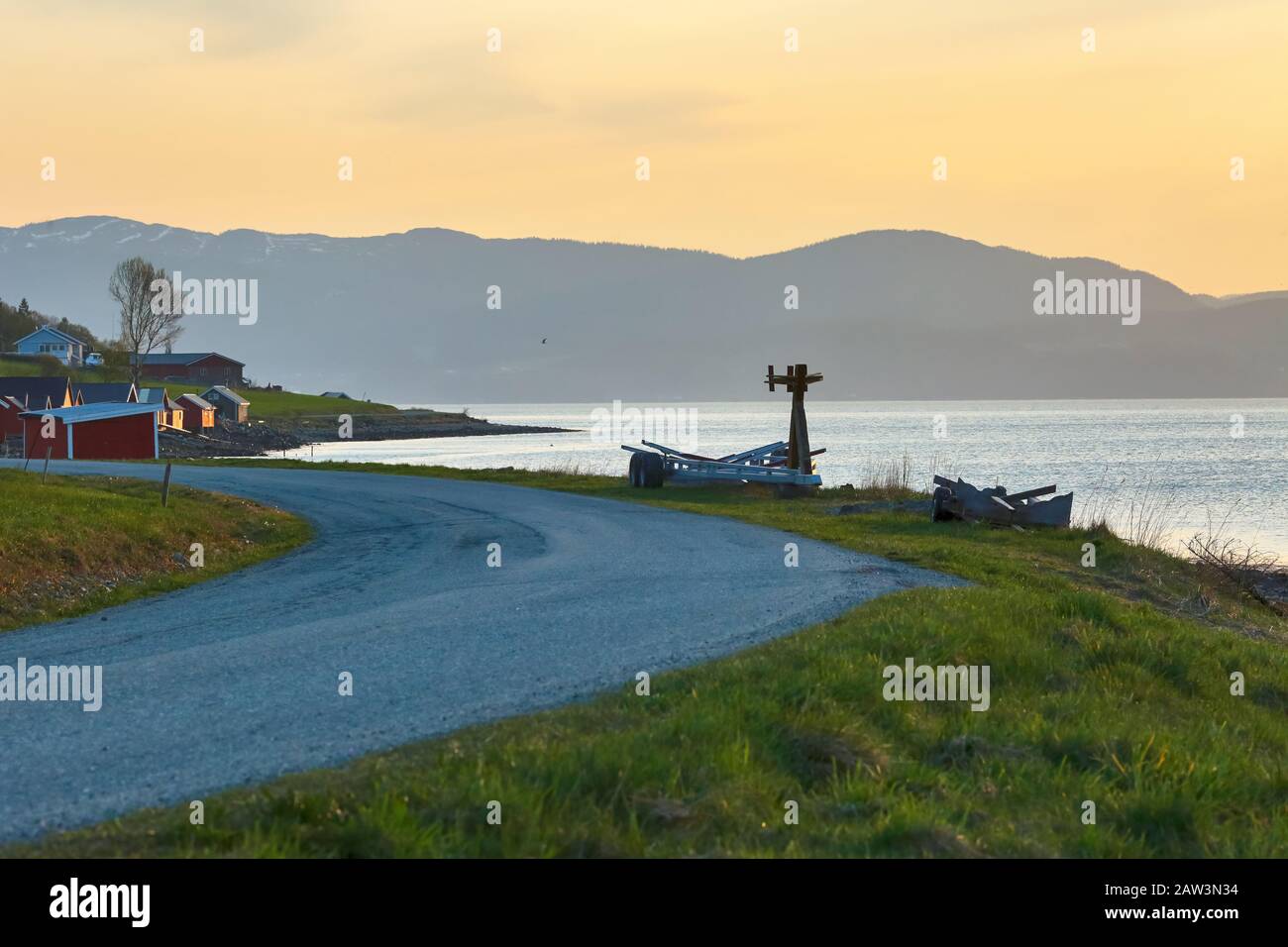 Sunset at Trondheim fjord, the road over the agricutural area Byneset ...
