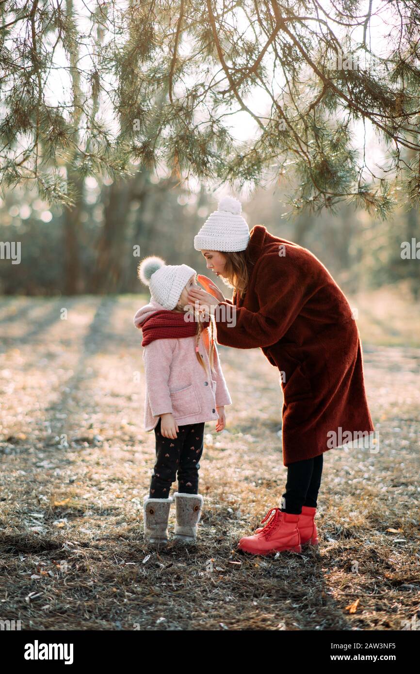 Mother and daughter are on the stroll in the pine forest Stock Photo ...