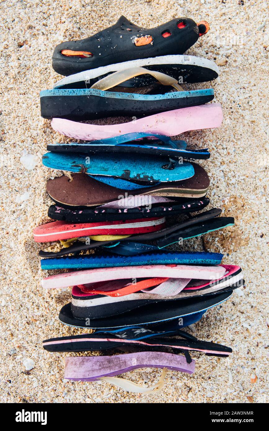 Plastic flip flops washed ashore Stock Photo - Alamy